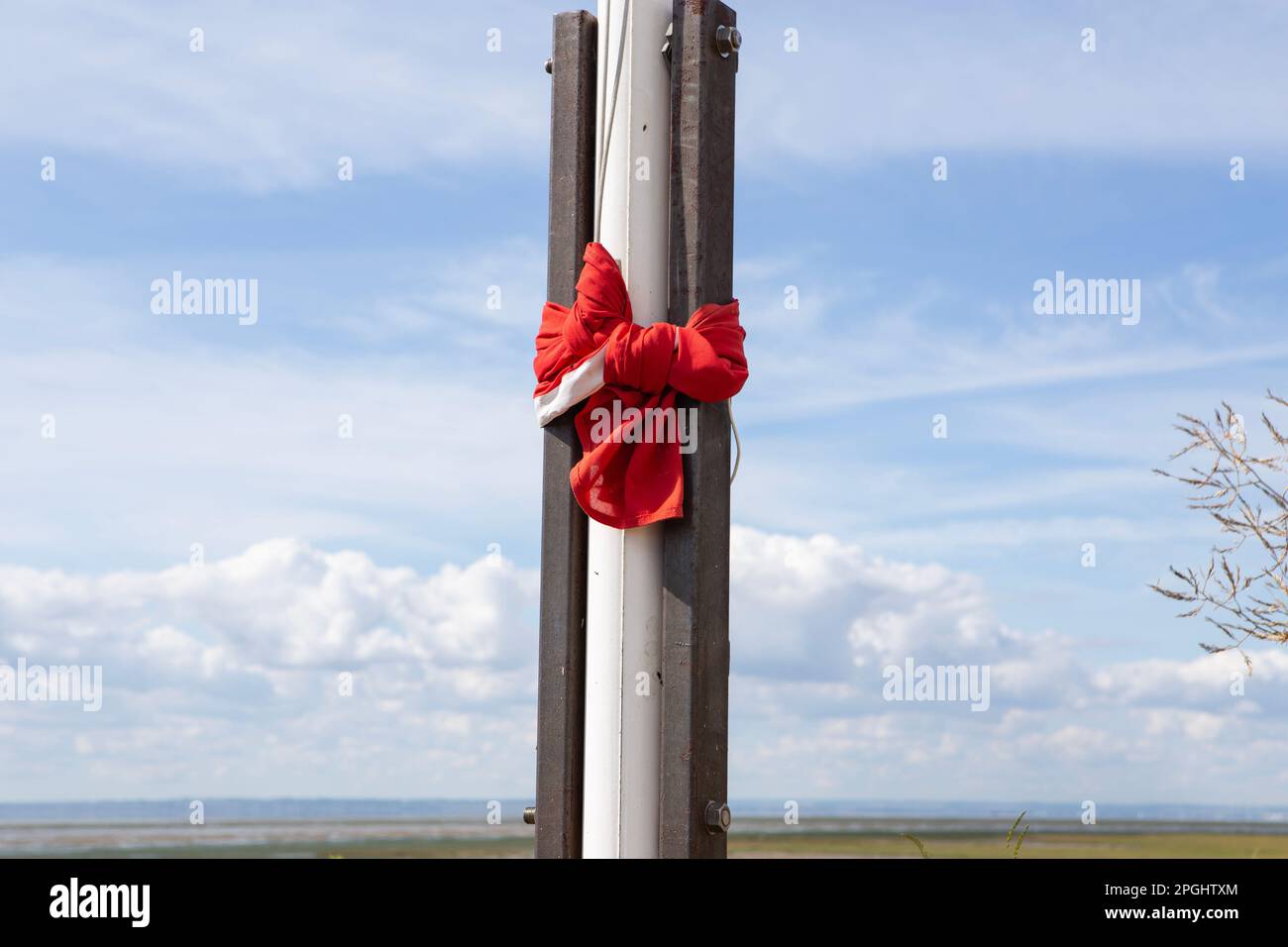 A red warning flag tied to a post, Foulness Island, Essex. When the ...