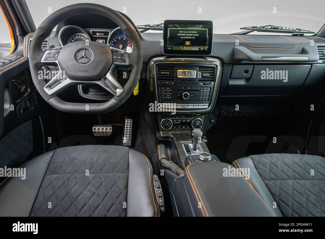 A modern vehicle interior is featured with a steering wheel and an ...