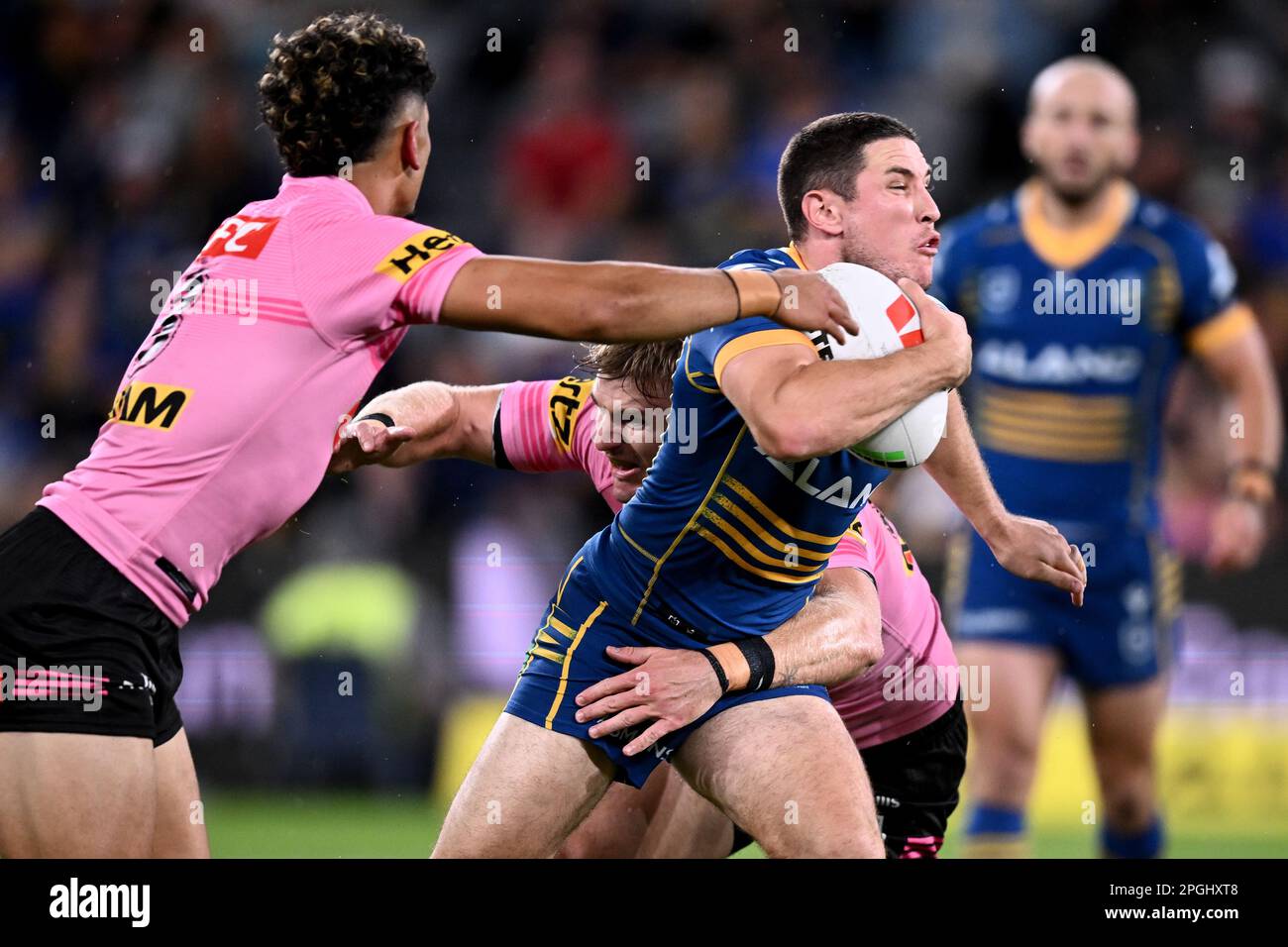 Mitchell Moses of the Eels is tackled by Luke Garner (right) and Izack ...