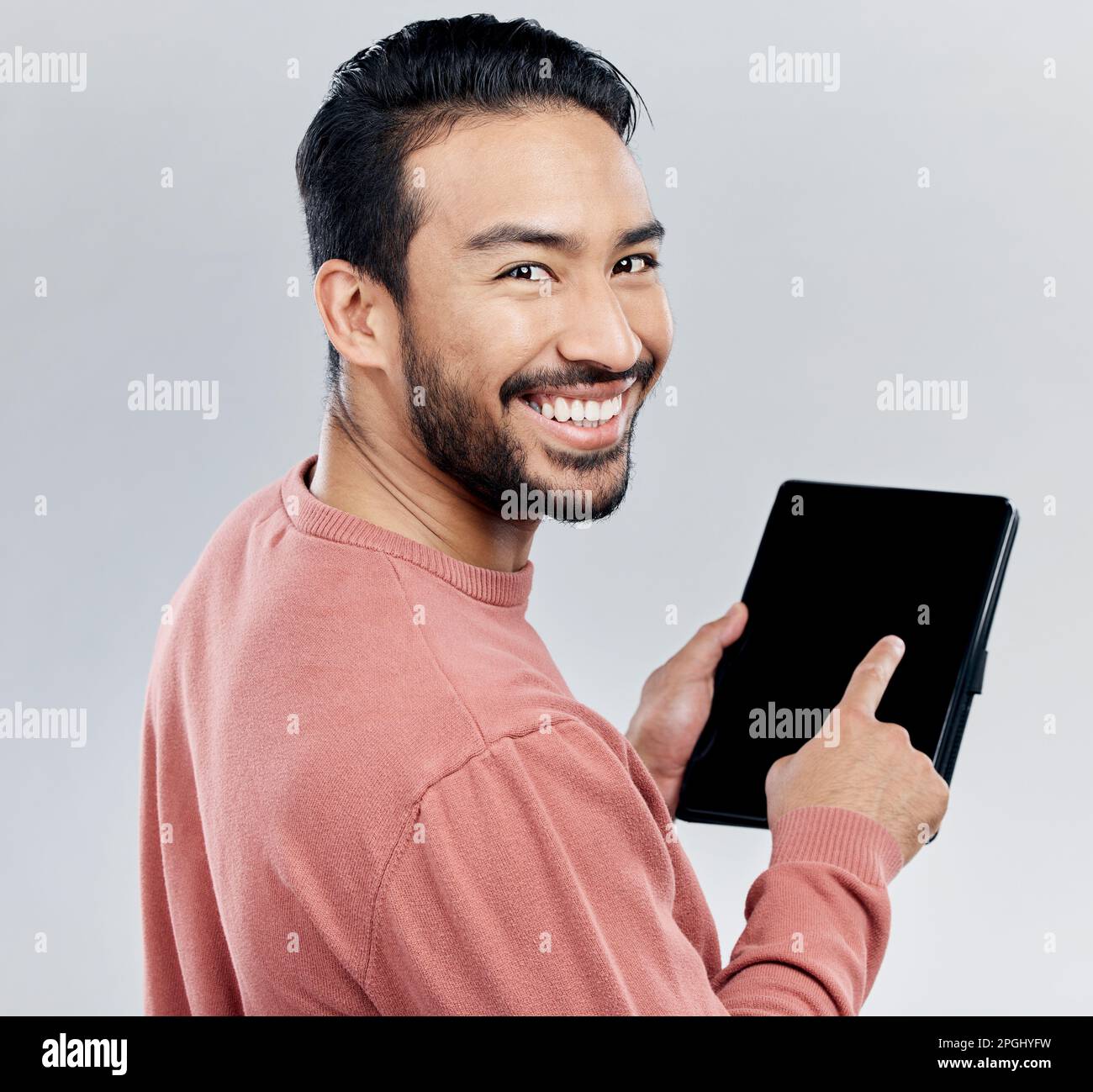 Portrait, smile and Asian man with tablet in studio isolated on a gray ...