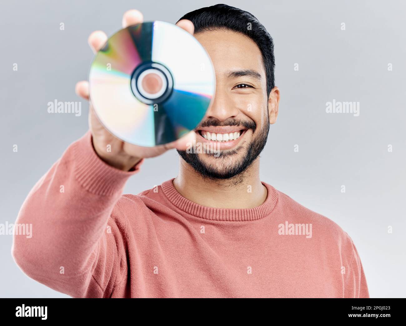Man, holding and compact disc in studio portrait for smile, happiness ...