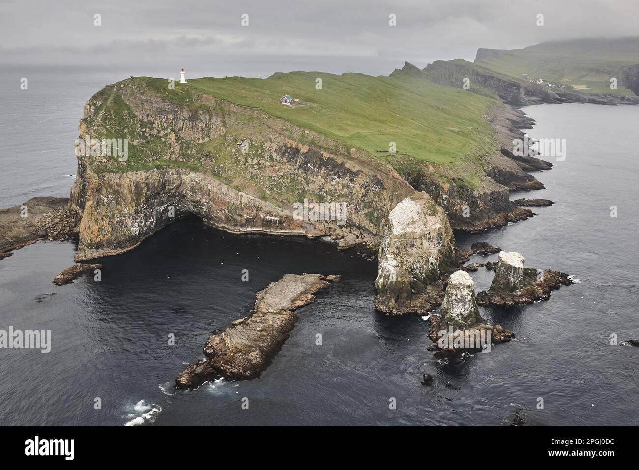 Mykines lighthouse and cliffs on Faroe islands from helicopter. Denmark ...
