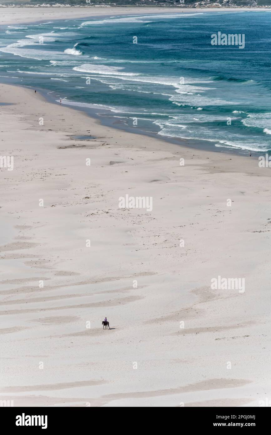 landscape with lone rider on white sands of Long Beach at Kommetje on ...
