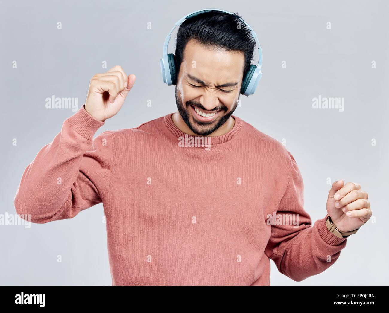 Fun, dance and Asian man with headphones, streaming music and happiness ...