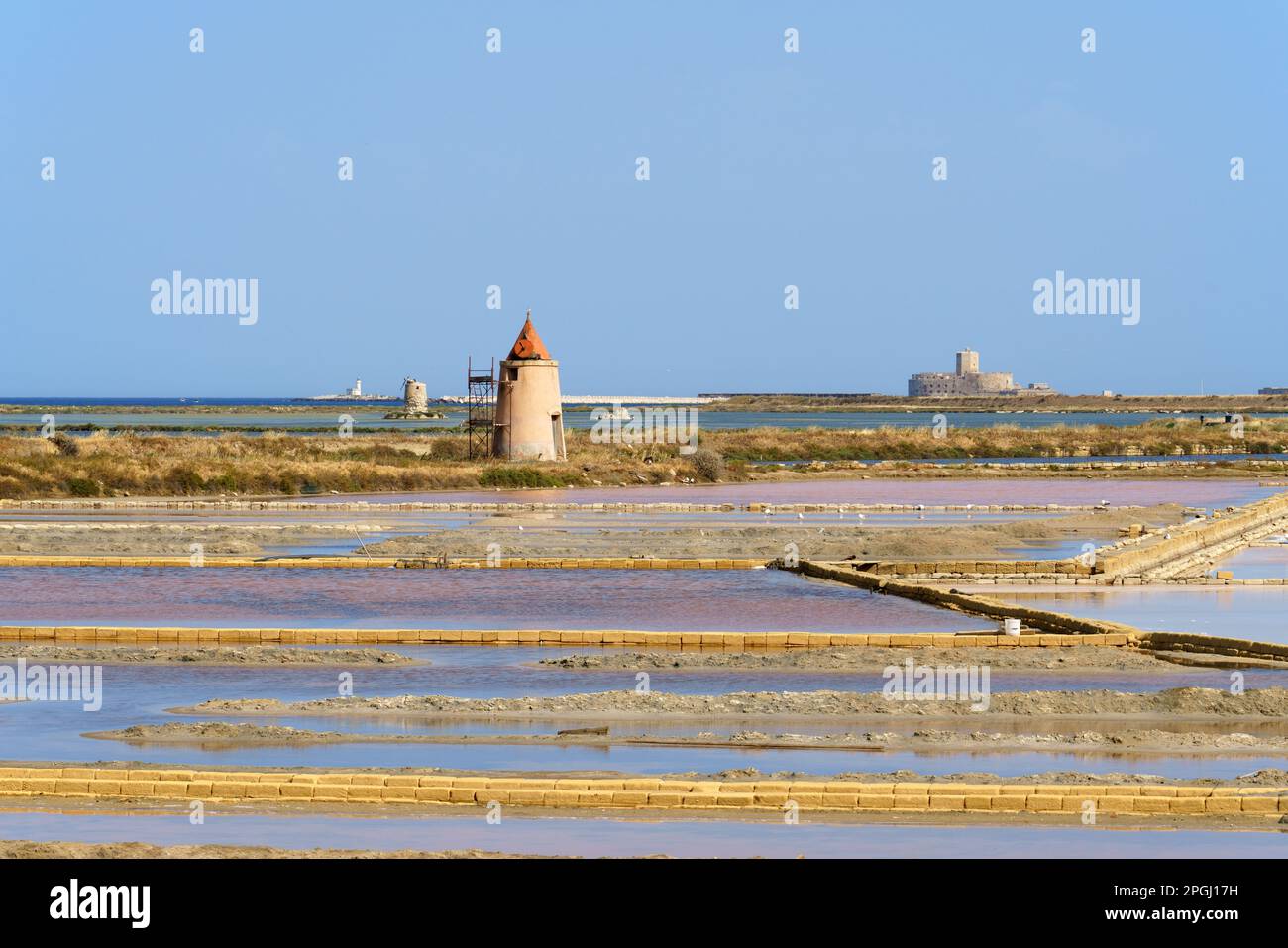 The salt pans of Trapani in Sicily, Italy. An ancient windmill and the ...