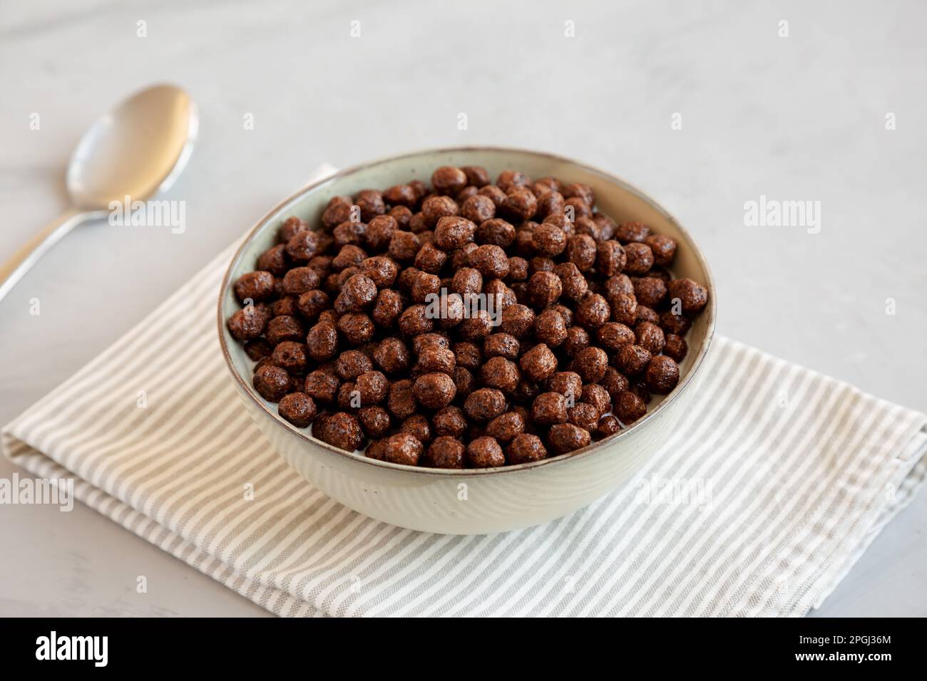 Chocolate Puff Cereal with Milk in a Bowl, side view Stock Photo - Alamy