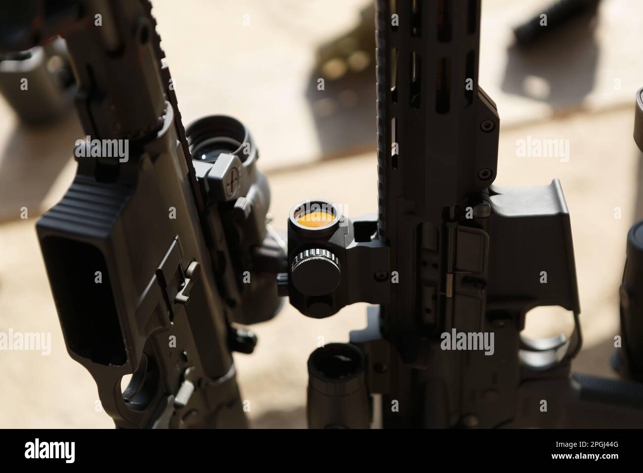 Modern American assault rifles on a weapon stand at the shooting range ...