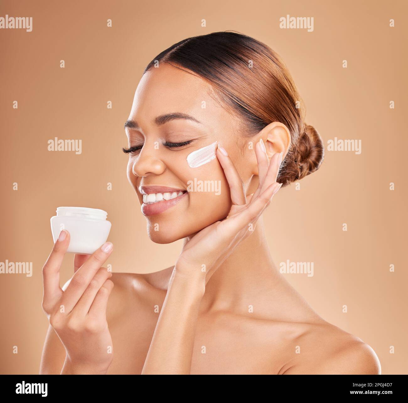 Woman, skincare cream jar and studio for beauty, wellness or self care ...