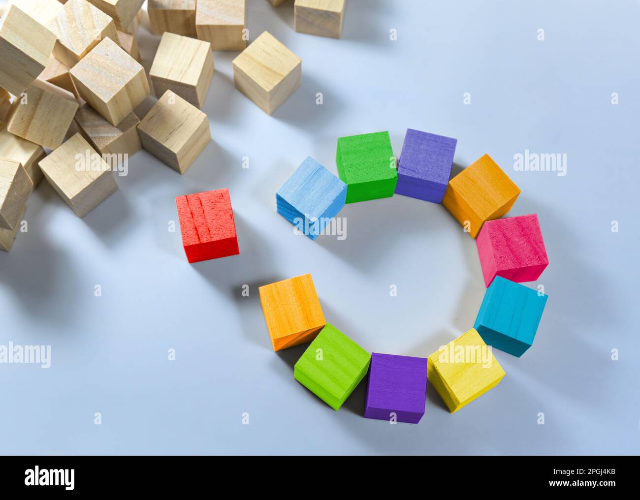 Cubes in different colors together form a circle with a gap, one is red ...