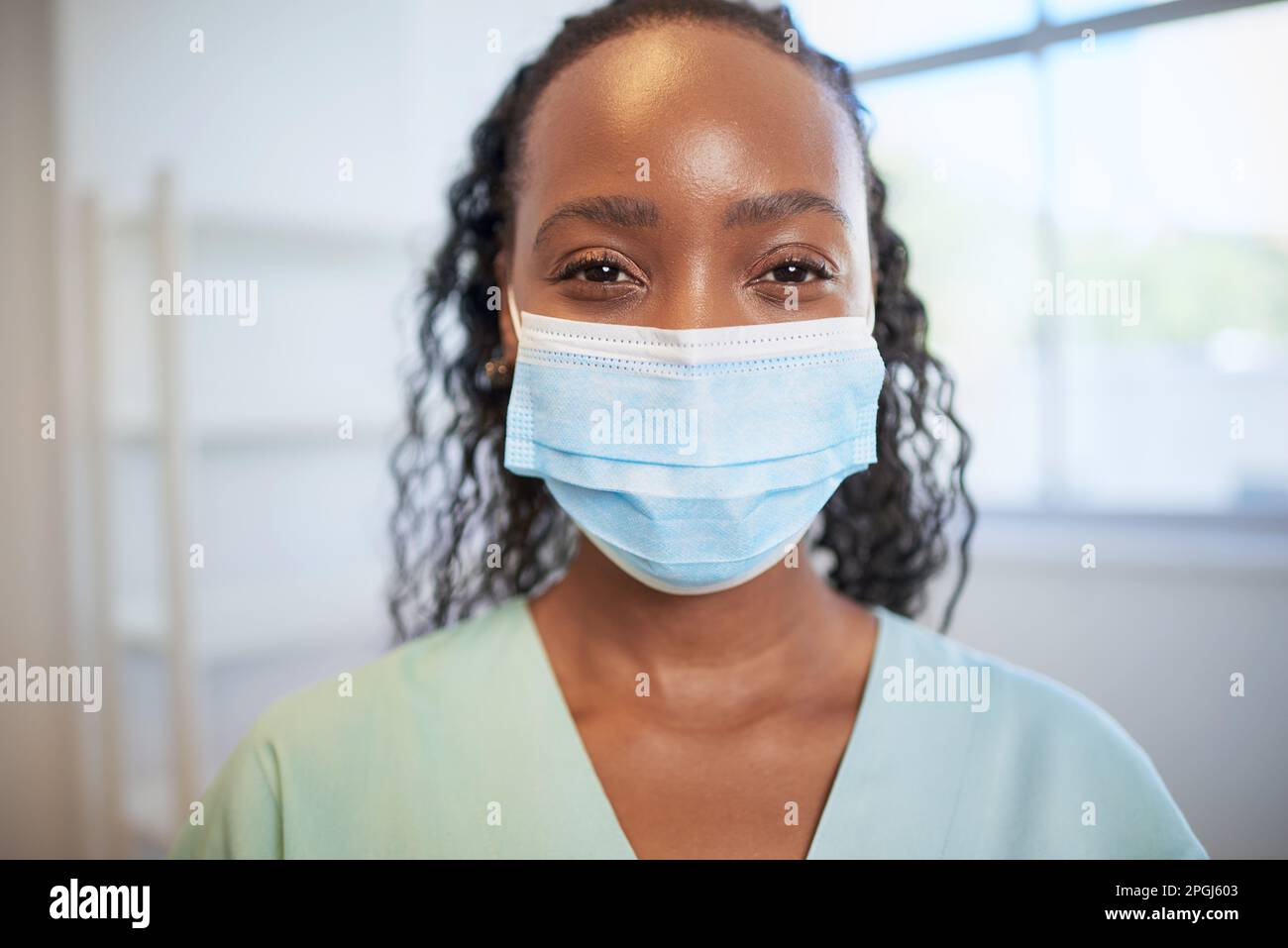 Close up portrait of junior doctor or nurse wearing surgical mask in ...