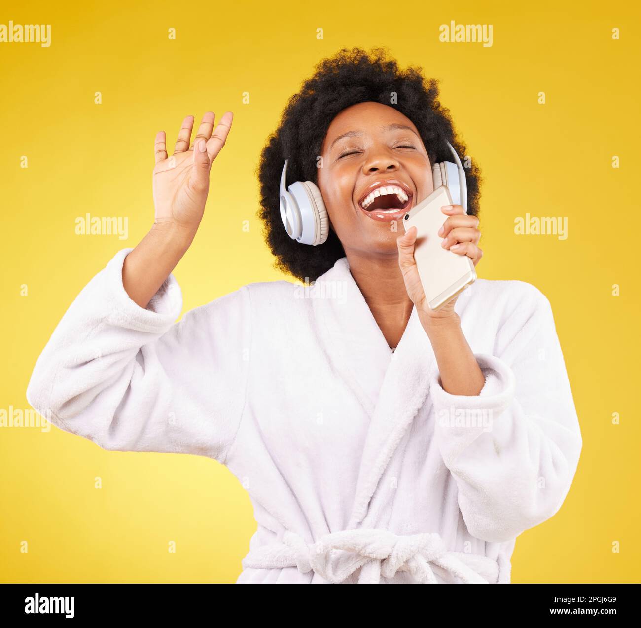 Black woman, music headphones and singing with phone in studio isolated ...