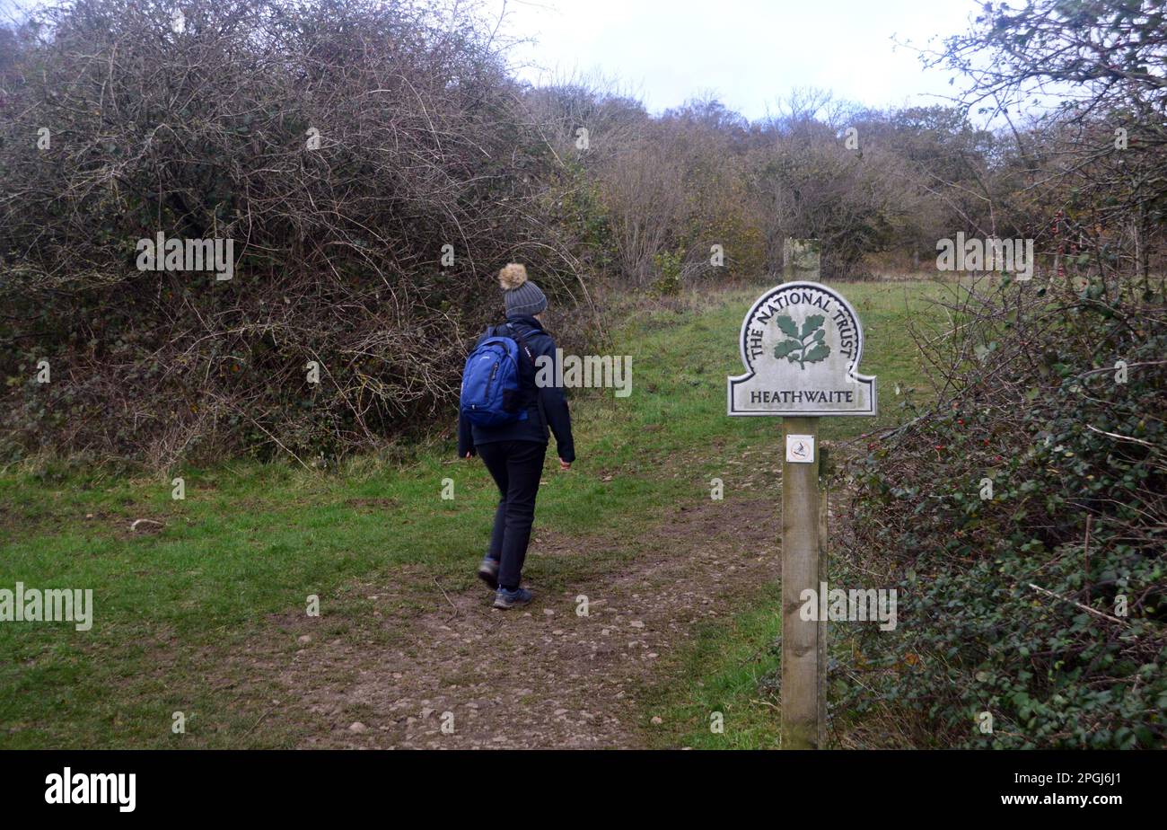 Lone Woman (Hiker) Walking past National Trust Signpost for Heathwaite ...