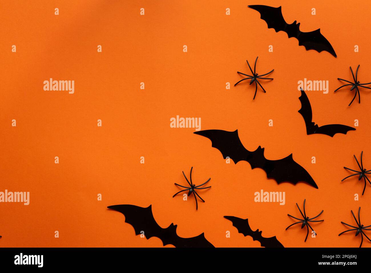 An orange background decoration for Halloween with a group of bats and ...