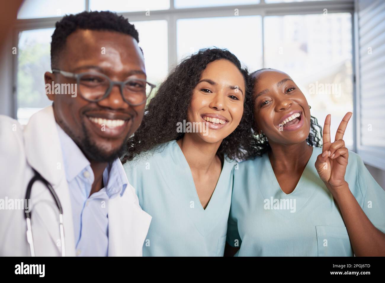 Fun selfie of doctor and nurses in hospital pulling silly faces and ...