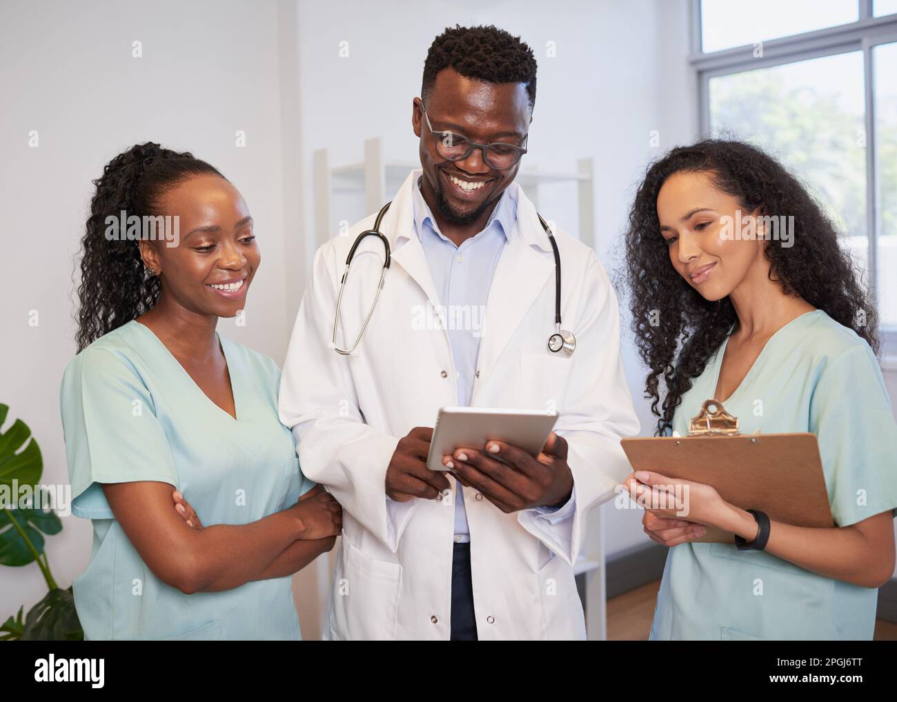 Three healthcare professionals stand hi-res stock photography and ...