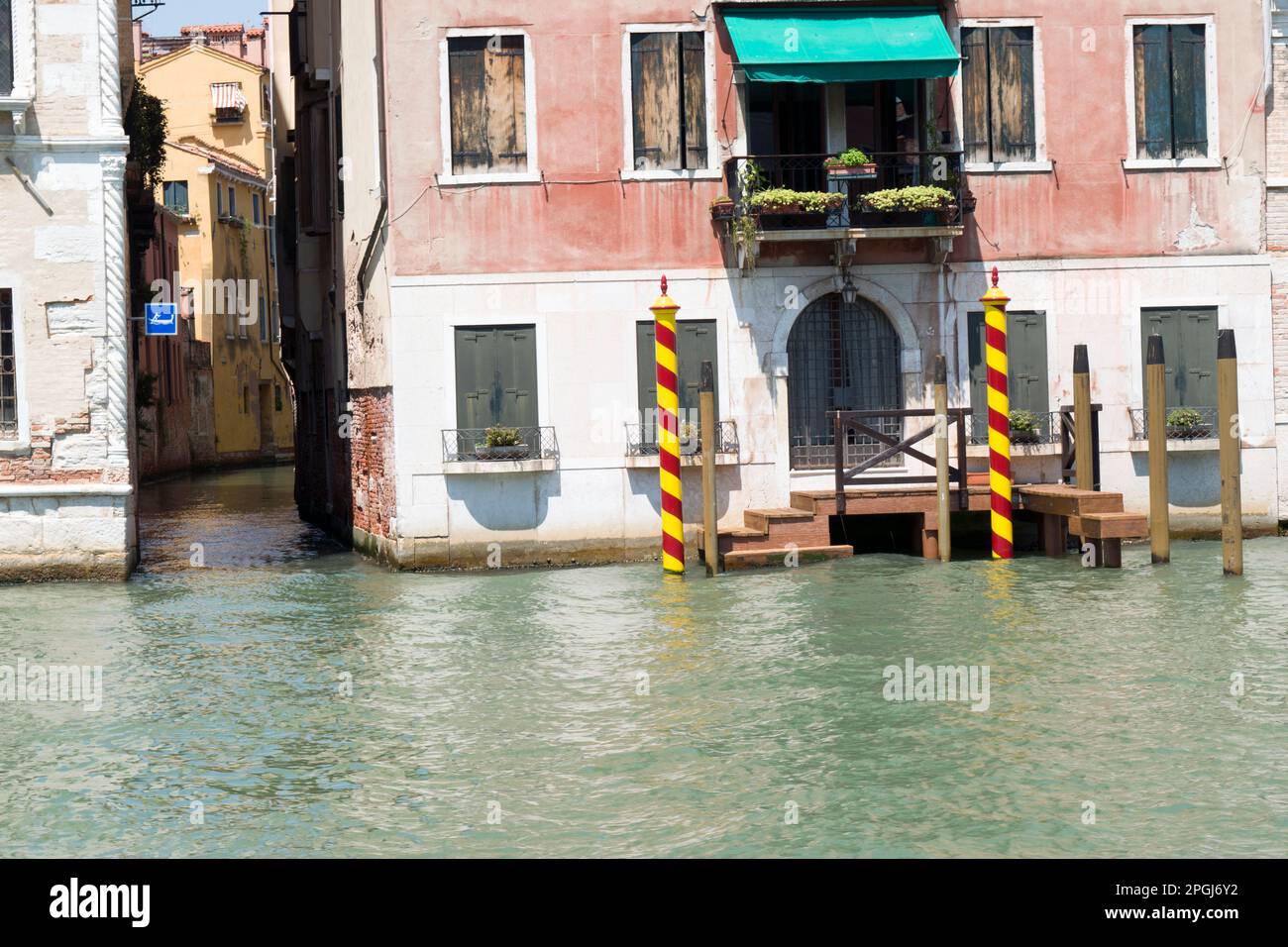 Venice’s yellow and red colored poles, brightly colored, painted with a ...