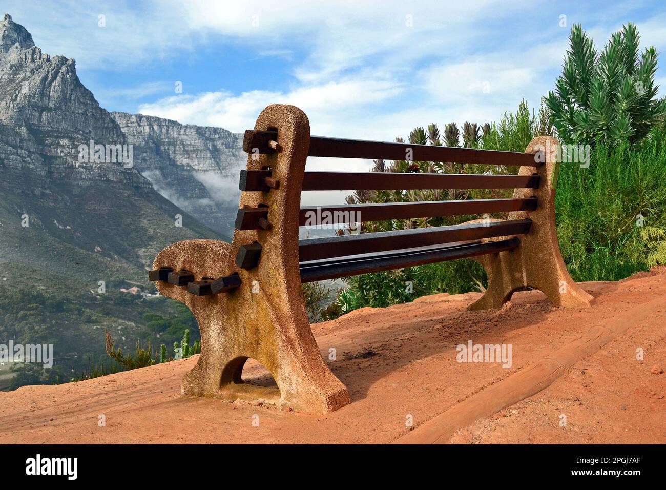 A scenic view of a bench overlooking a mountain range with rolling ...