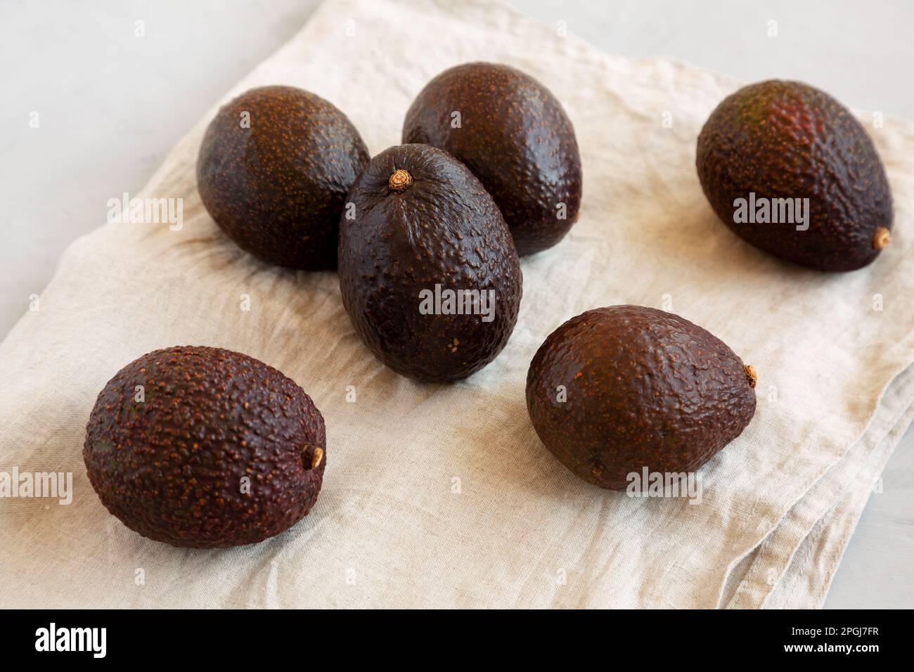 Raw Organic Hass Avocados on a gray background, side view Stock Photo ...