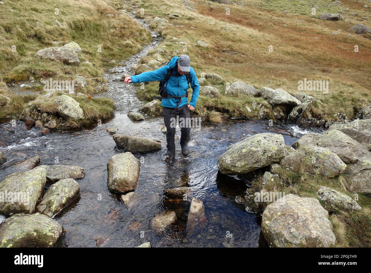 Man (Hiker) Crossing Stake Gill Beck on the Stake Pass in the Mickleden ...