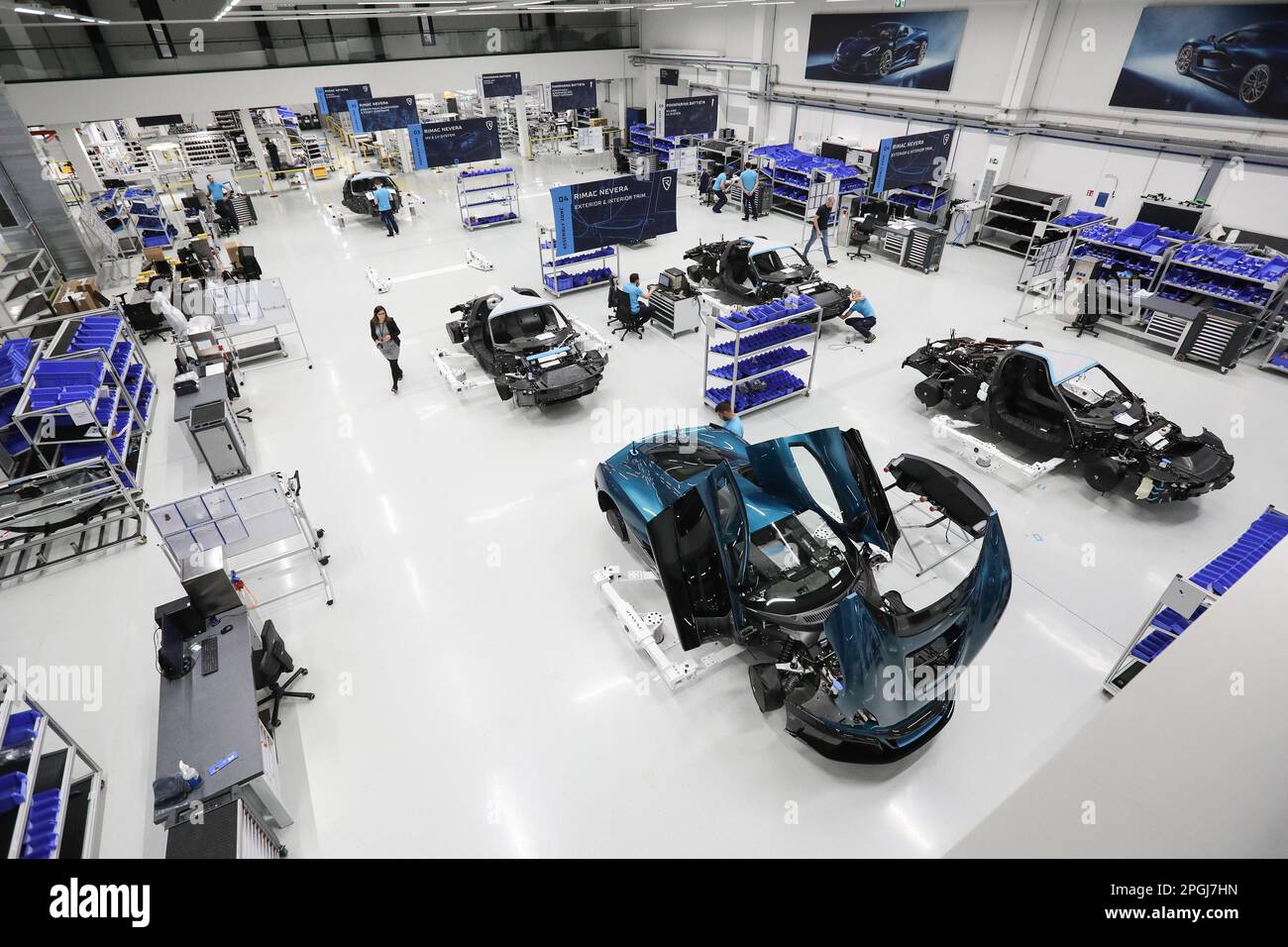 Employees working on an assembly line producing Electric Hyper car ...