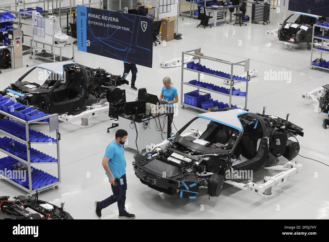 Employees working on an assembly line producing Electric Hyper car ...