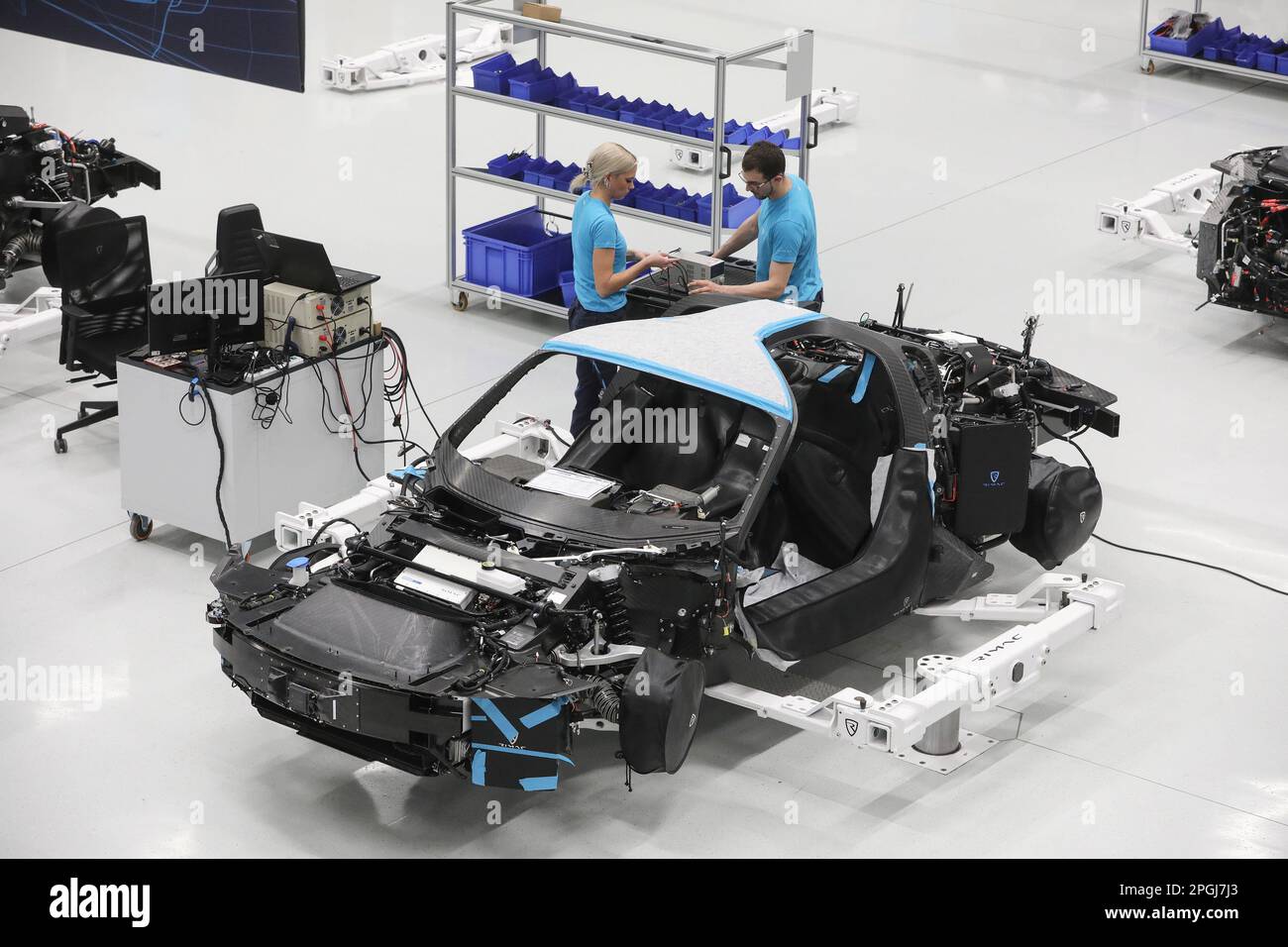 Employees working on an assembly line producing Electric Hyper car ...