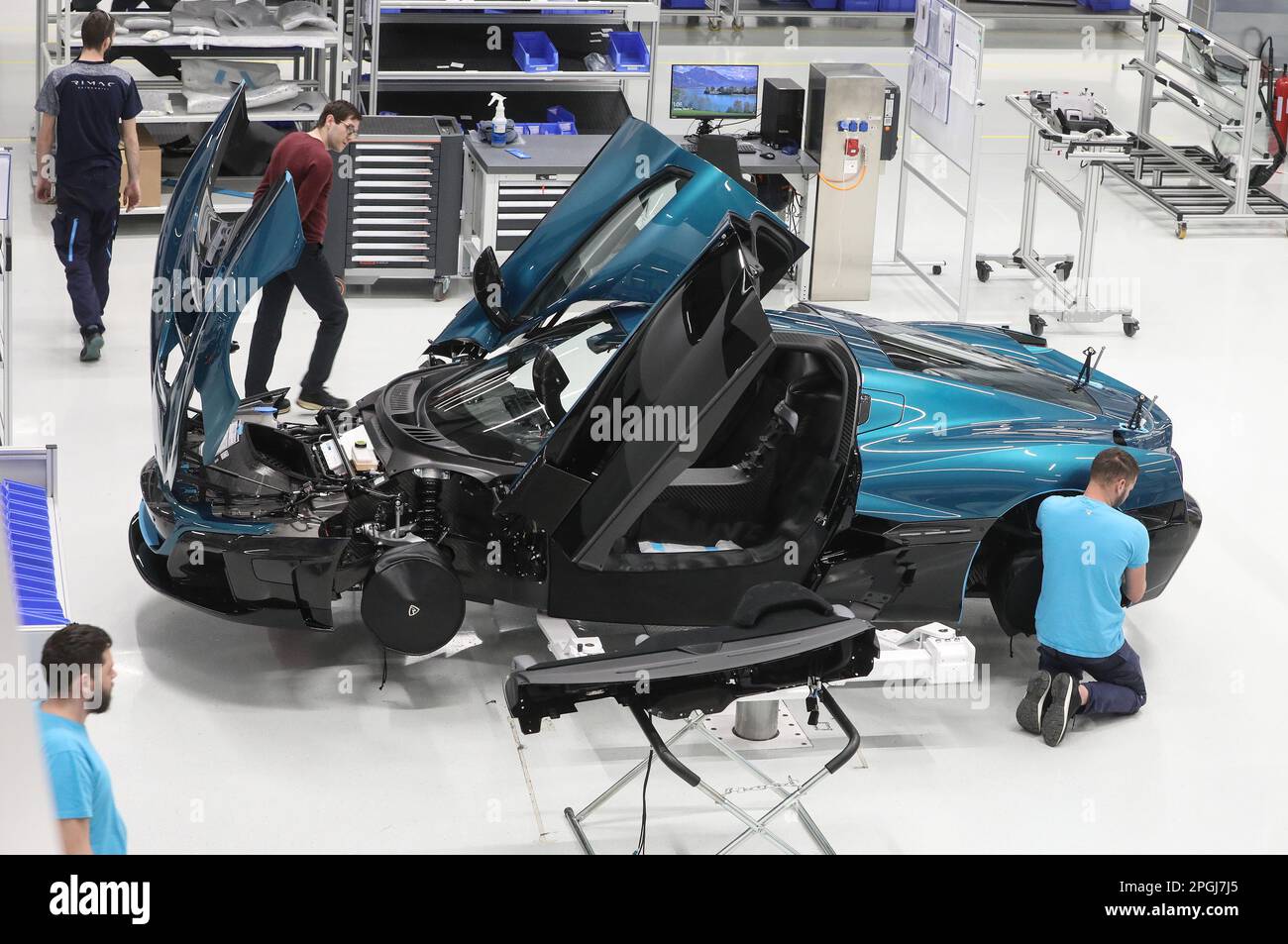 Employees working on an assembly line producing Electric Hyper car ...