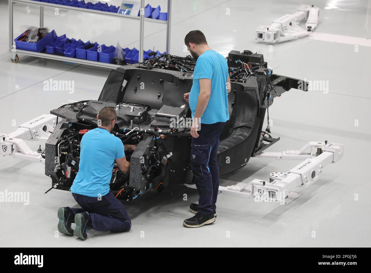 Employees working on an assembly line producing Electric Hyper car ...