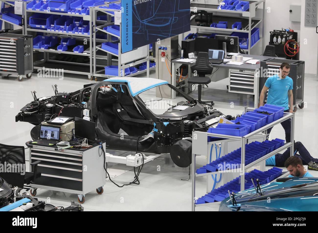 Employees working on an assembly line producing Electric Hyper car ...