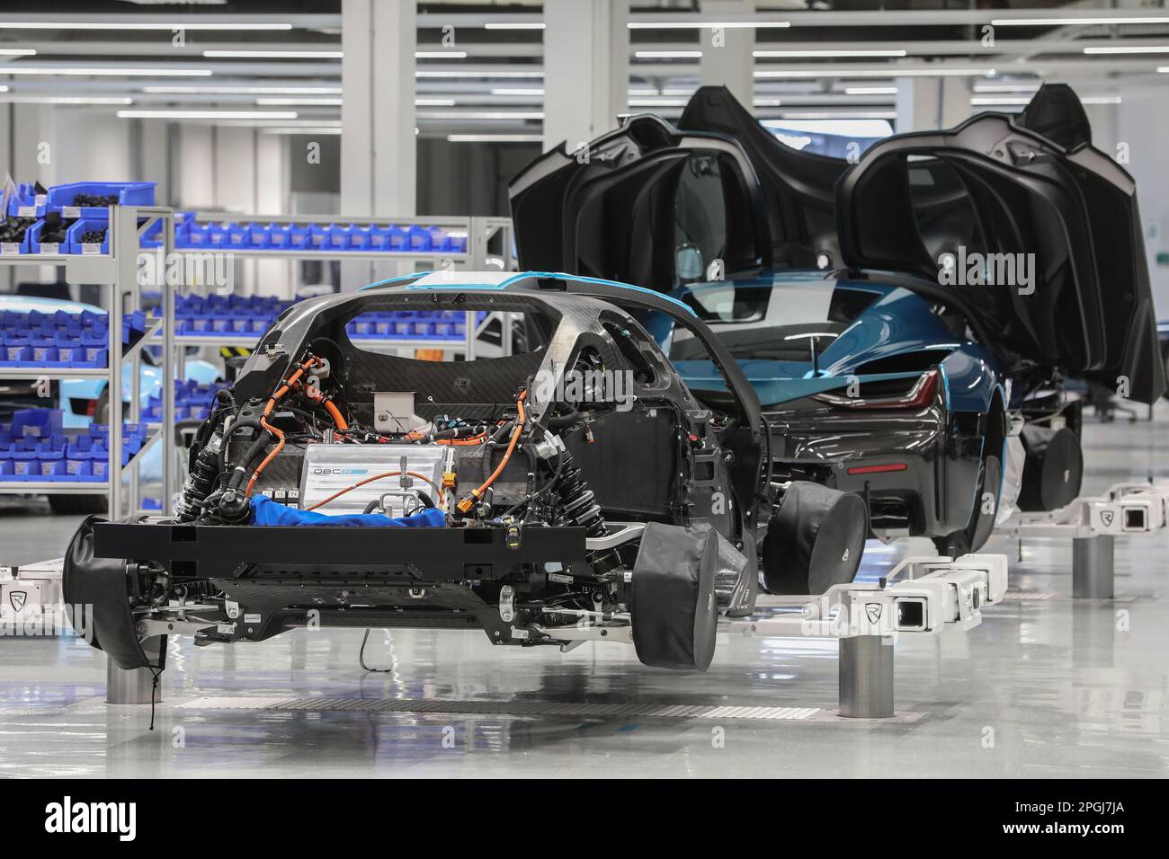 Employees working on an assembly line producing Electric Hyper car ...
