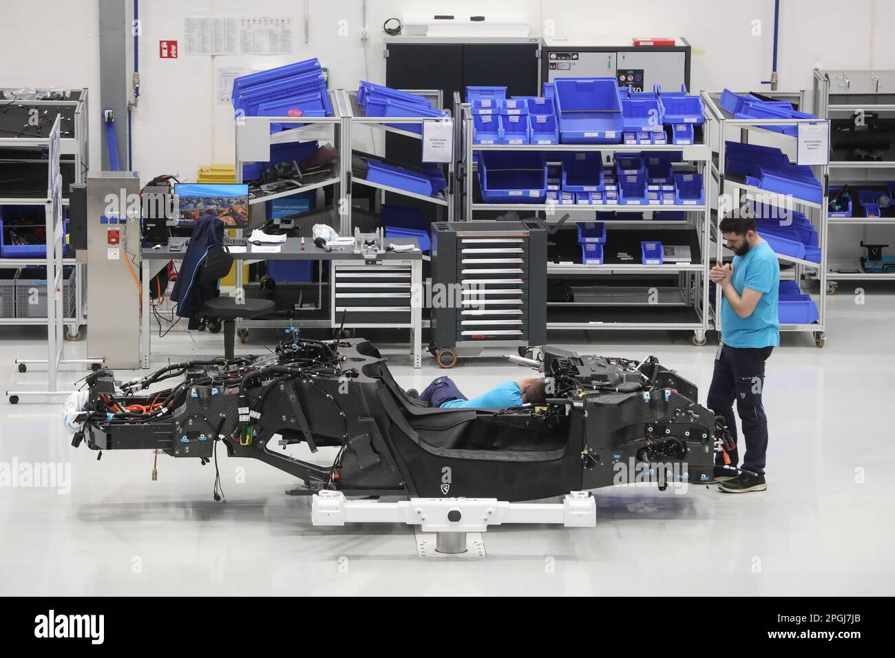 Employees working on an assembly line producing Electric Hyper car ...