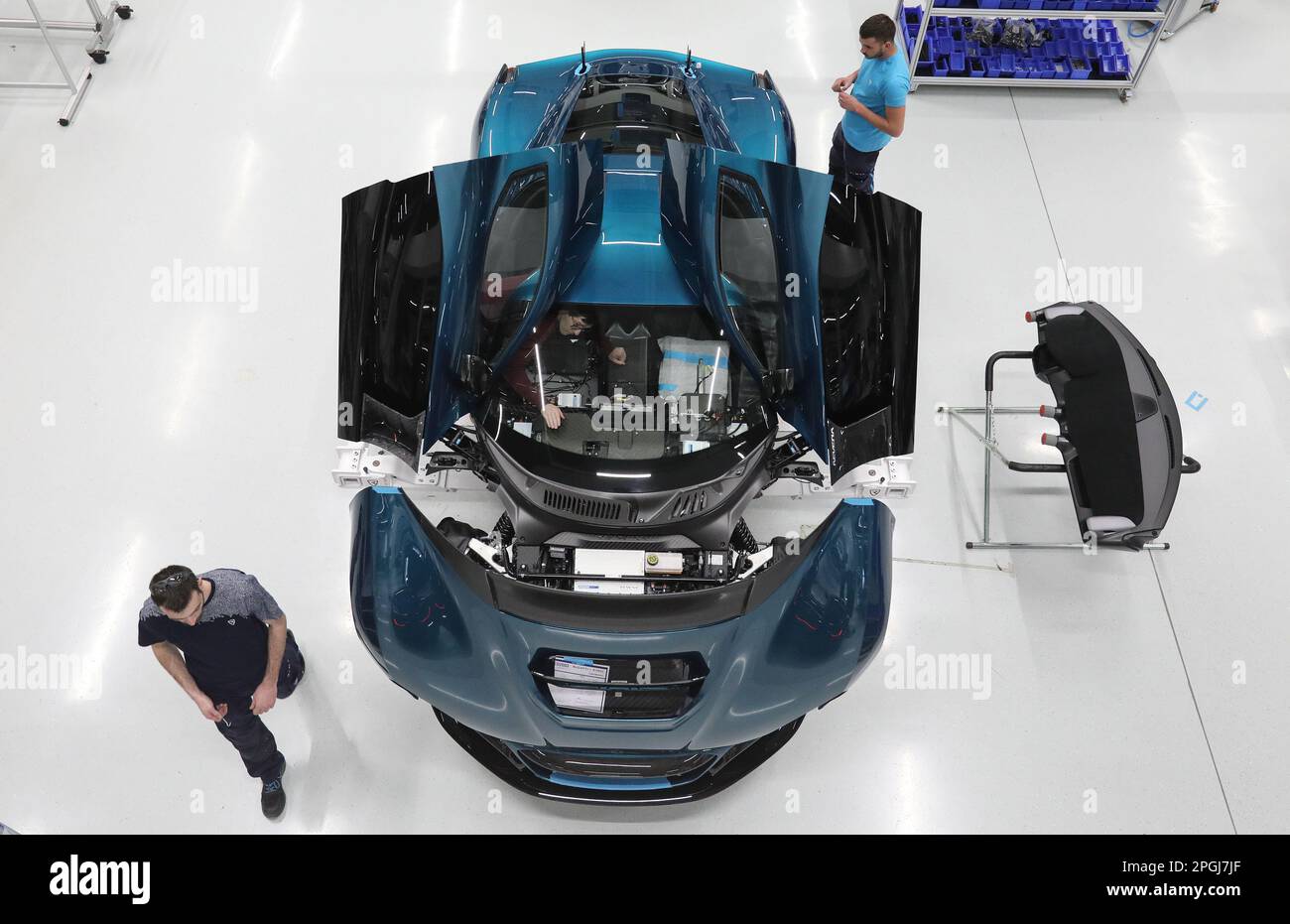 Employees working on an assembly line producing Electric Hyper car ...
