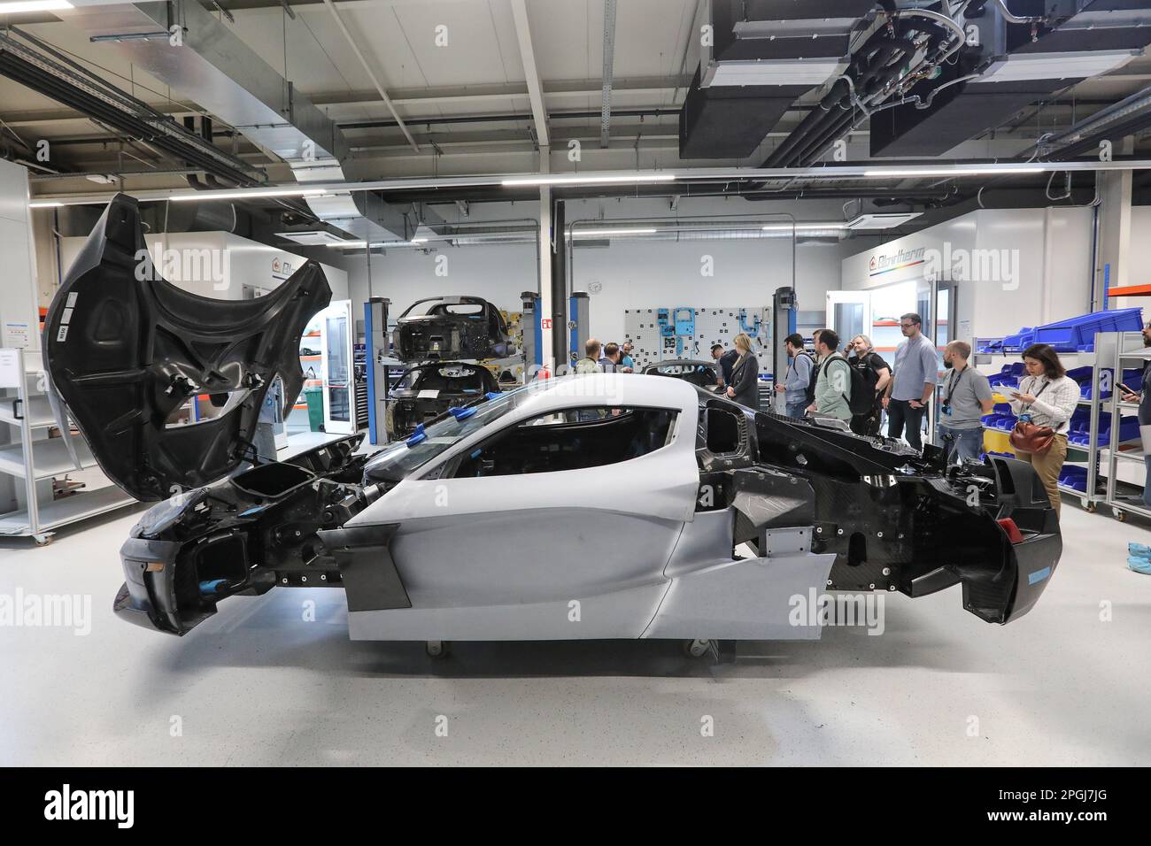 Employees working on an assembly line producing Electric Hyper car ...