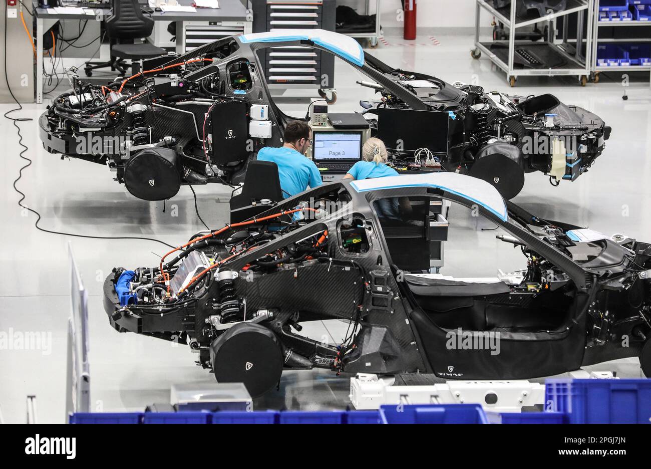 Employees working on an assembly line producing Electric Hyper car ...