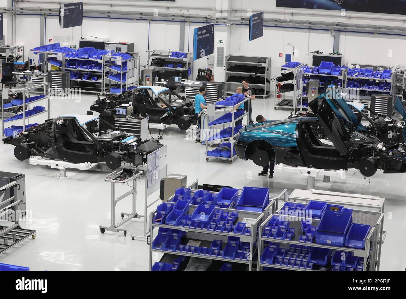 Employees working on an assembly line producing Electric Hyper car ...