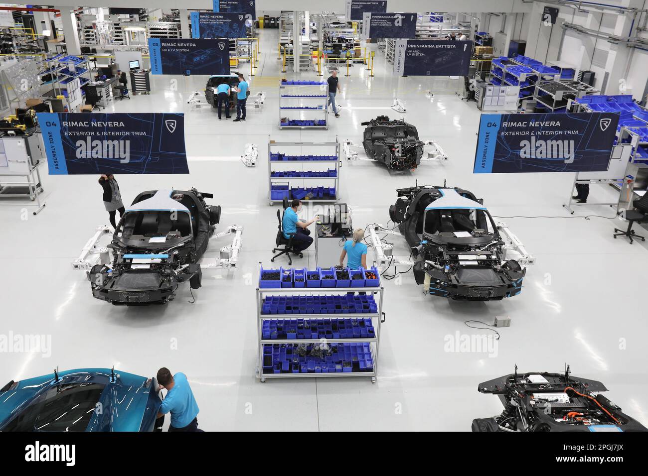 Employees working on an assembly line producing Electric Hyper car ...