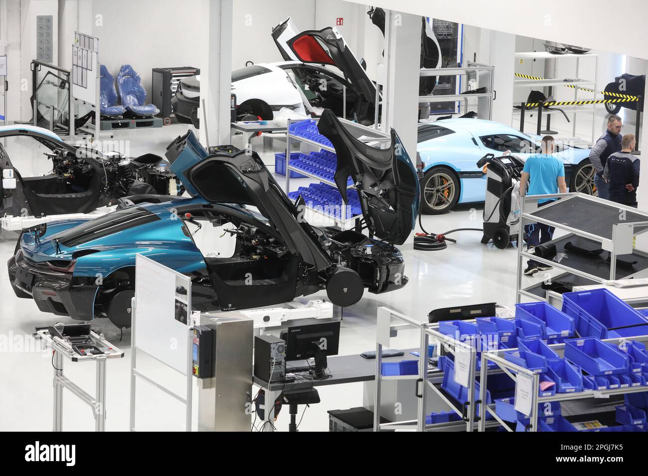 Employees working on an assembly line producing Electric Hyper car ...
