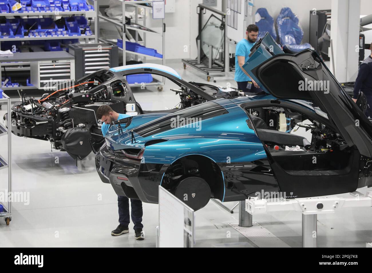 Employees working on an assembly line producing Electric Hyper car ...