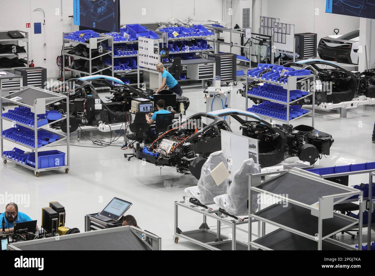Employees working on an assembly line producing Electric Hyper car ...