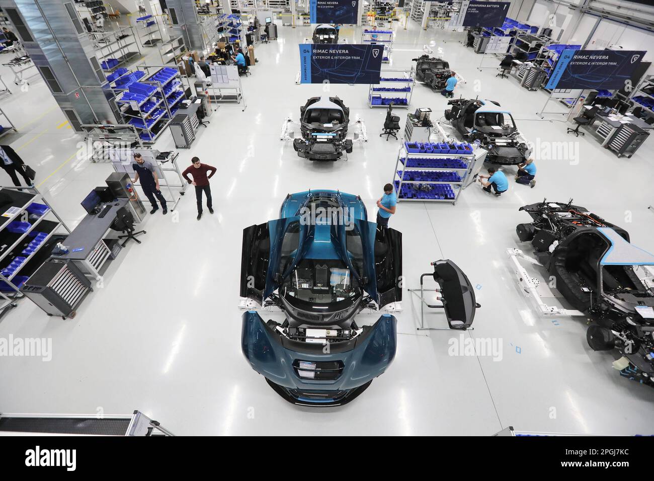 Employees working on an assembly line producing Electric Hyper car ...