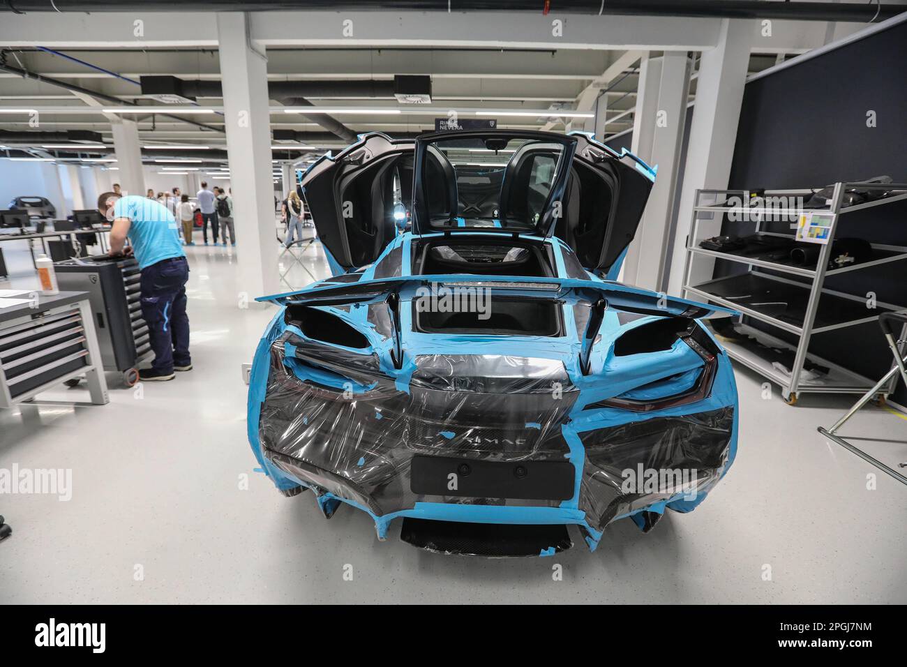 Employees working on an assembly line producing Electric Hyper car ...