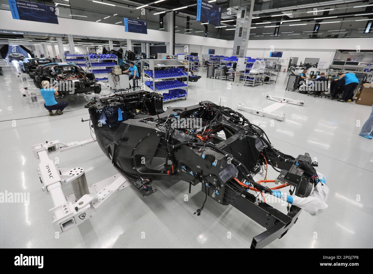 Employees working on an assembly line producing Electric Hyper car ...