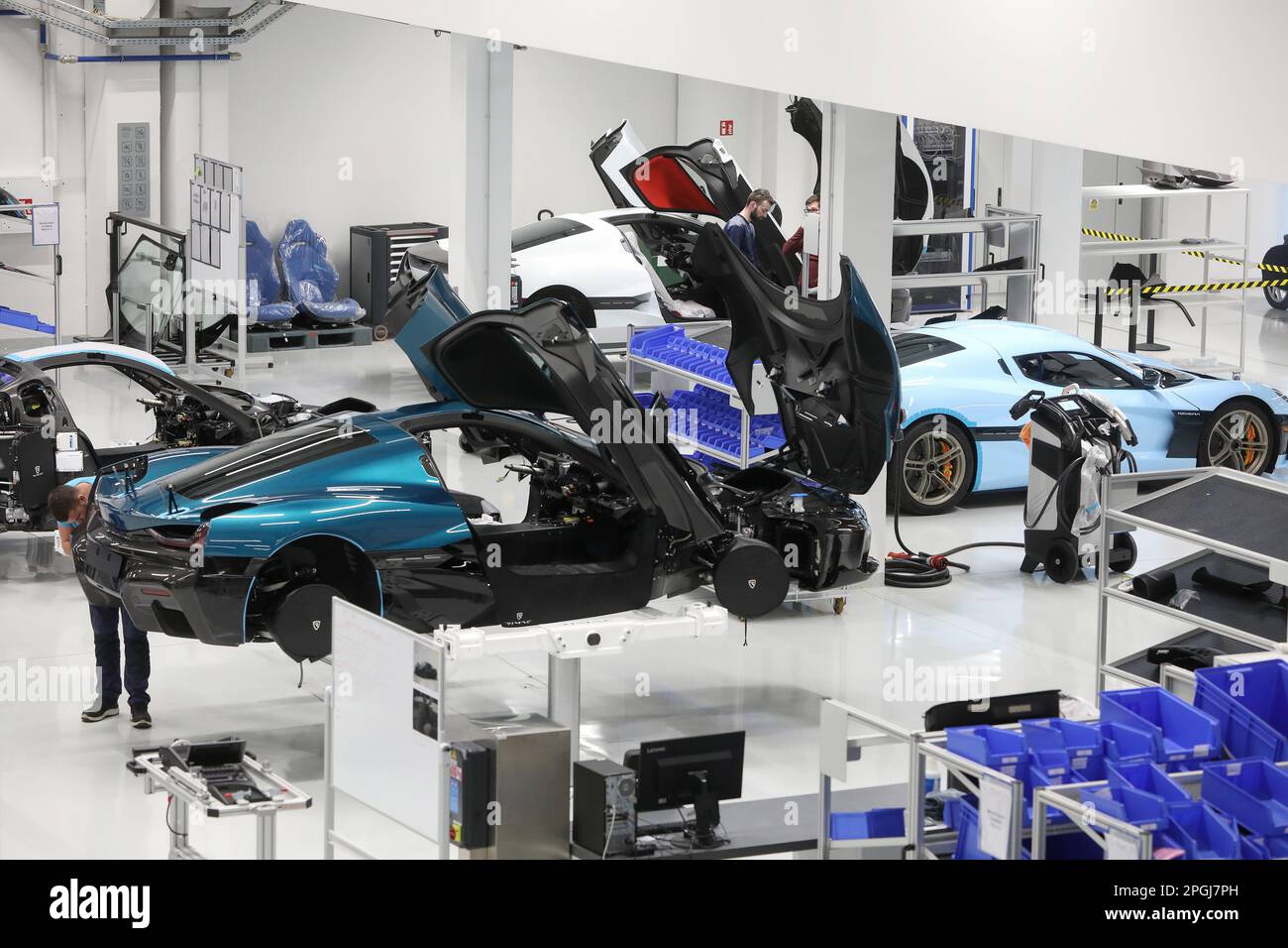 Employees working on an assembly line producing Electric Hyper car ...