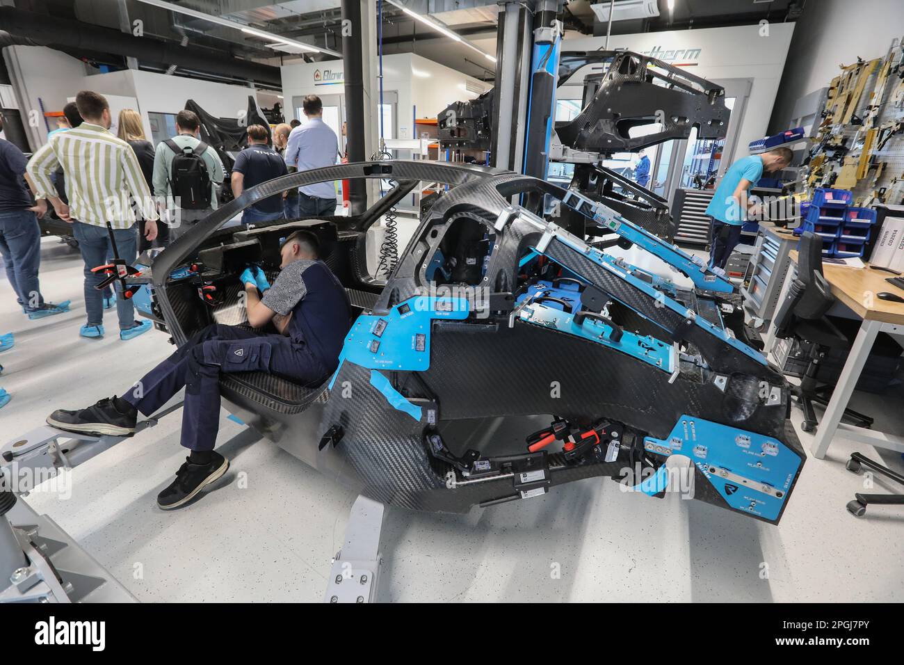 Employees working on an assembly line producing Electric Hyper car ...