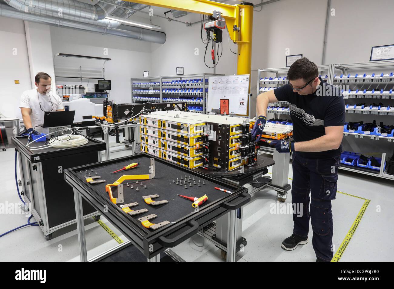 Employees working on an assembly line producing Electric Hyper car ...