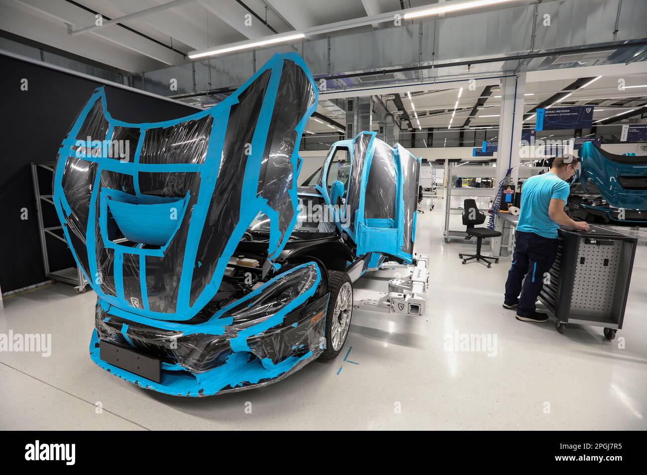 Employees working on an assembly line producing Electric Hyper car ...