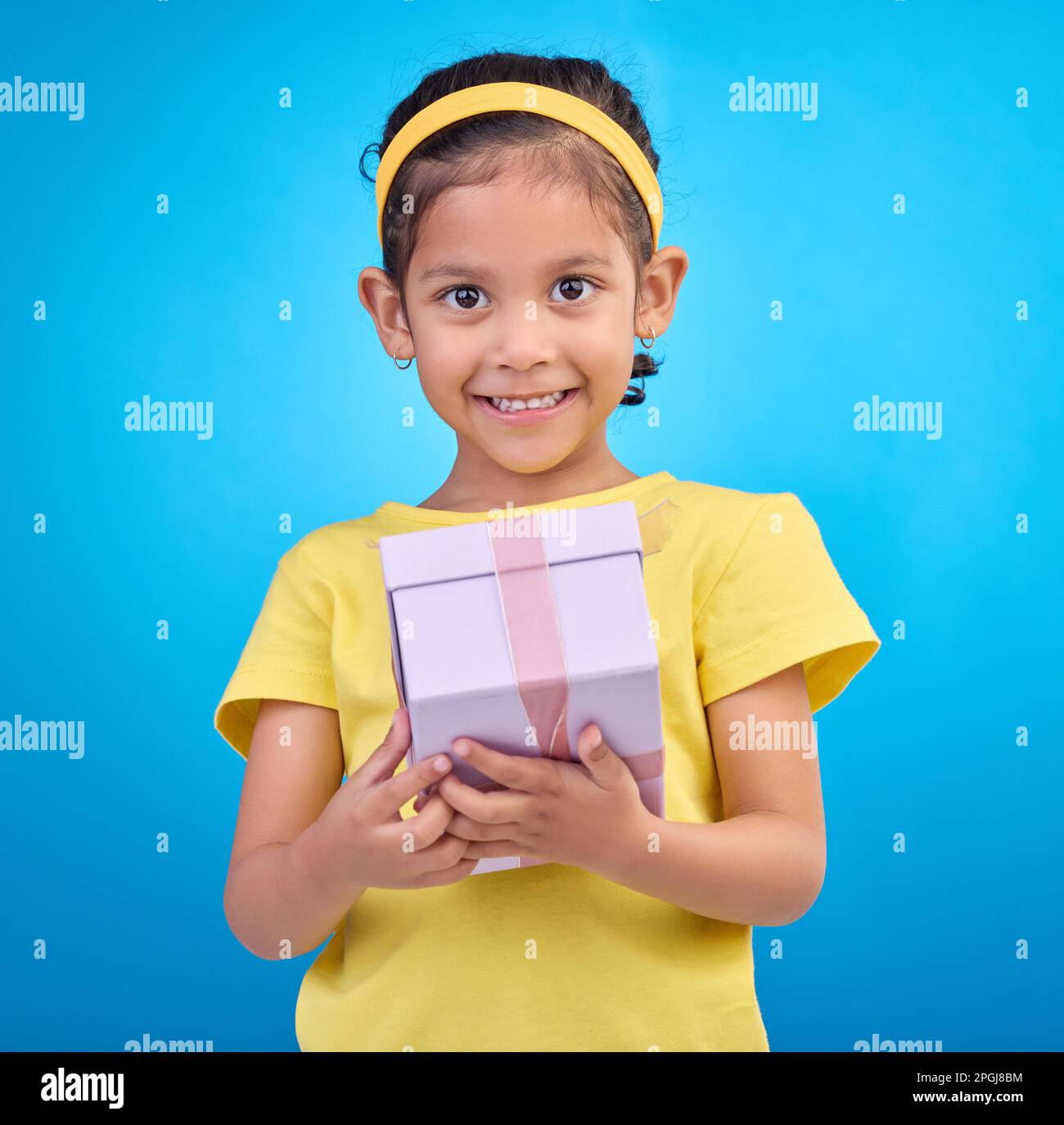Gift, box and smile with portrait of girl in studio for celebration ...