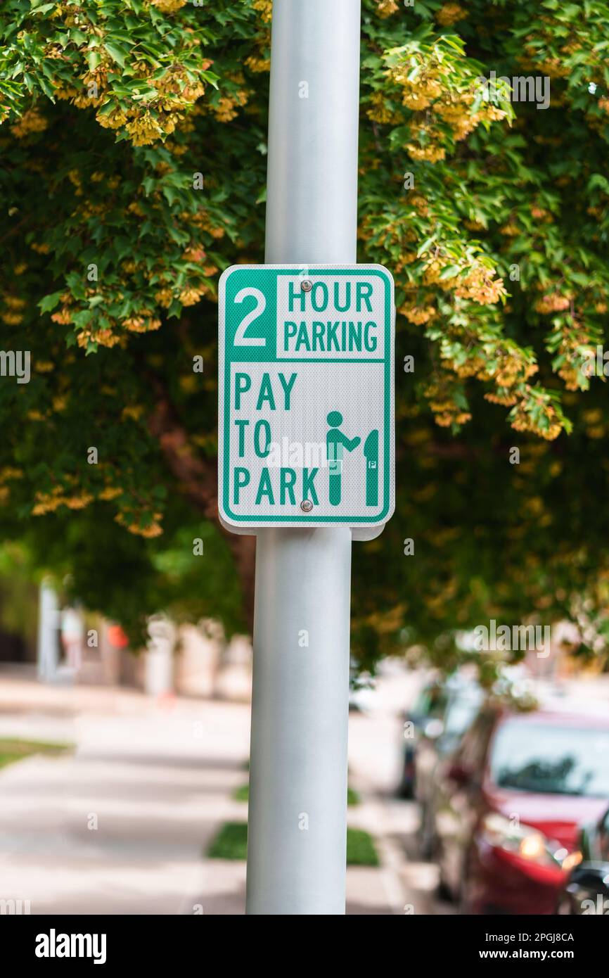 A street sign indicating that parking is prohibited and requires ...