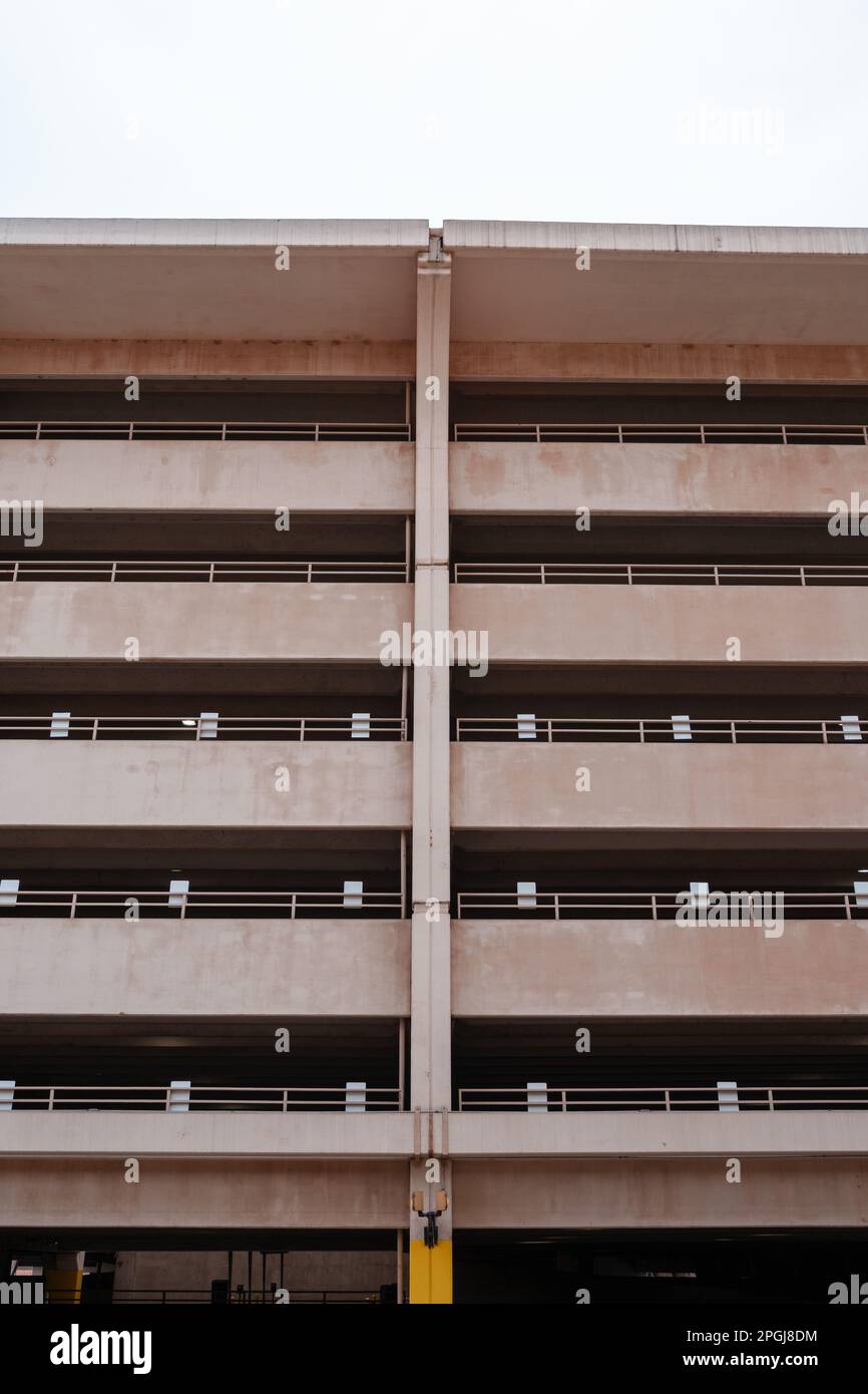 A modern, multi-level parking structure in an urban apartment complex ...