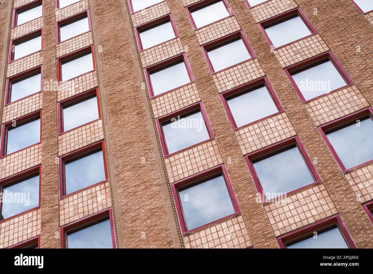 A modern office building with multiple windows Stock Photo - Alamy